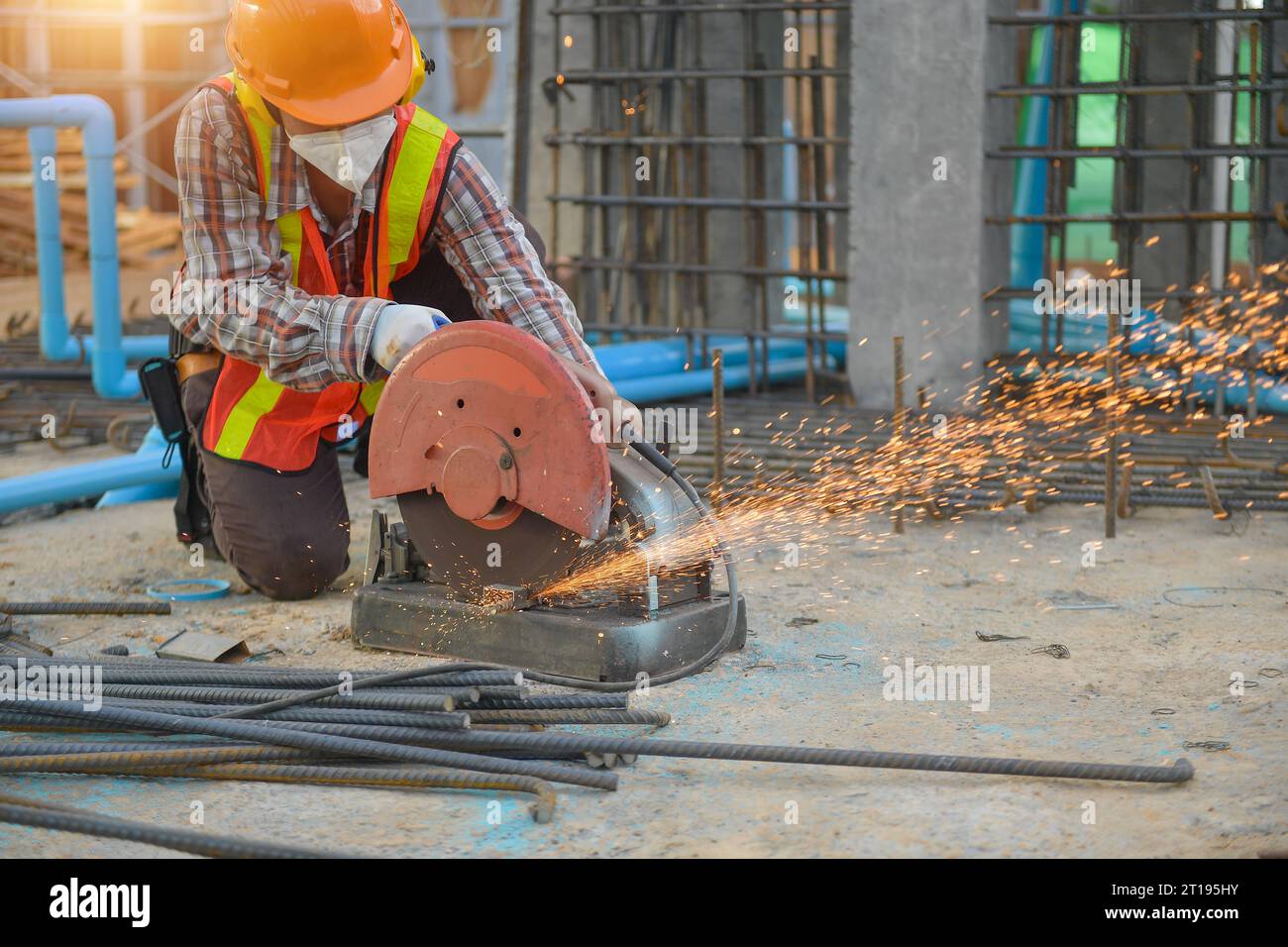 Construction worker cutting steel with a grinder on a construction site ...
