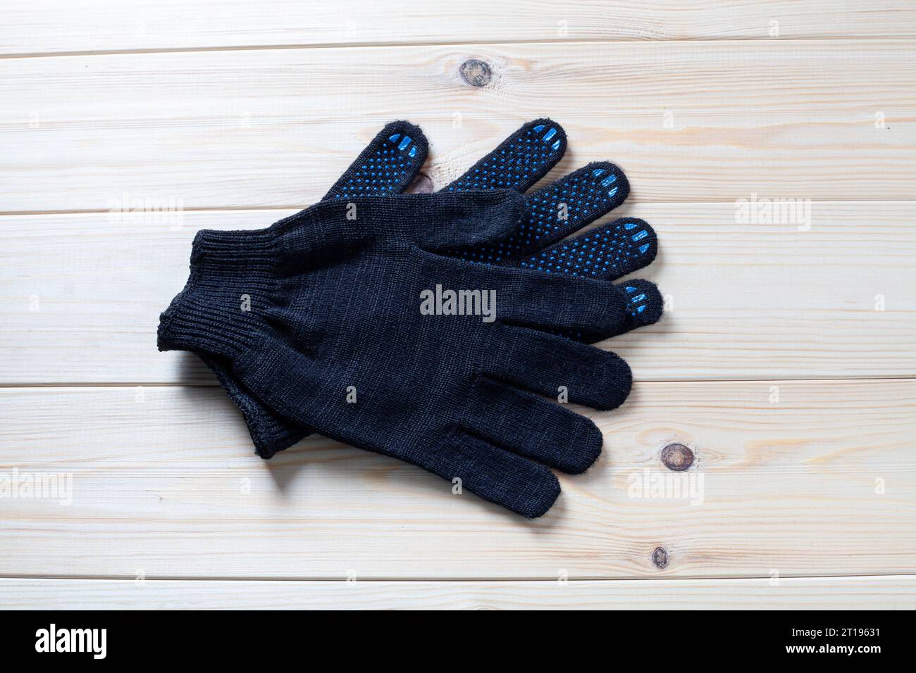 pair of black working gloves with rubber dots Stock Photo - Alamy