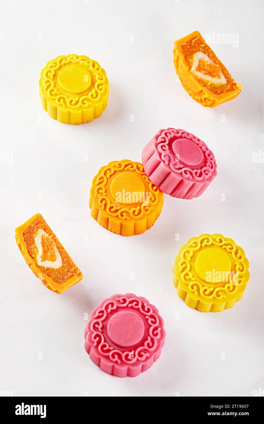 Overhead view of assorted multi coloured mooncakes on a white ...