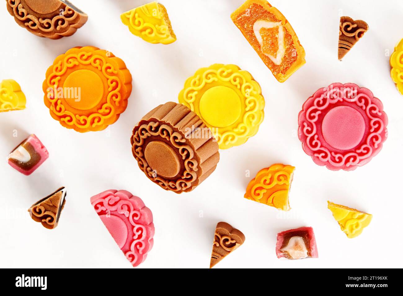 Overhead view of assorted multi coloured mooncakes on a white ...