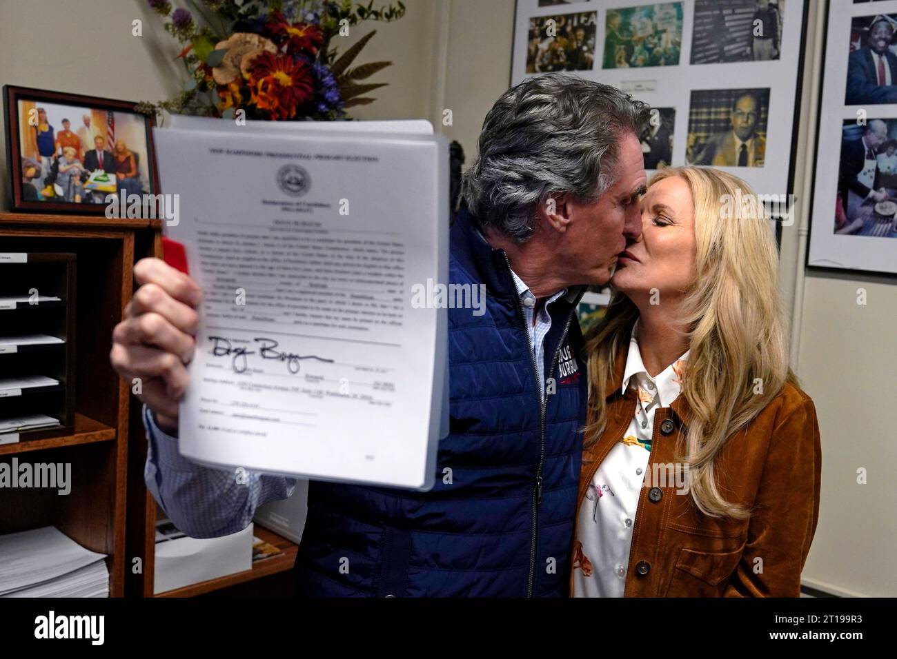 North Dakota Gov Doug Burgum Kisses His Wife Kathryn After Signing Up