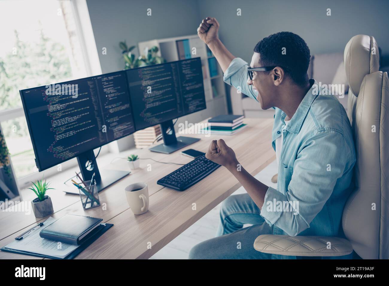 Side shot of crazy young guy celebrating his code works without bugs he ...