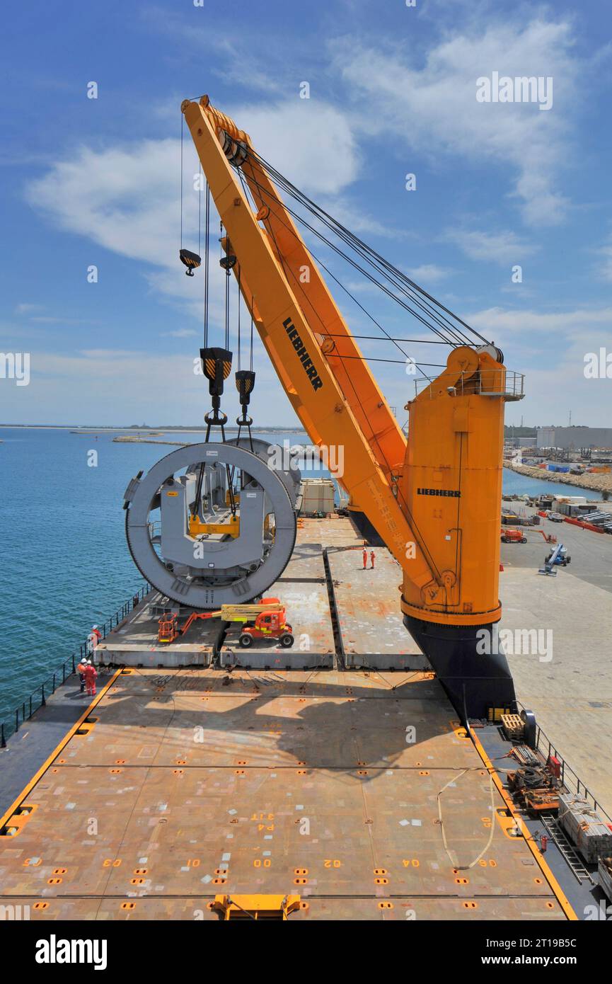 A newly constructed rail car dumper being loaded on to a shipping ferry ...