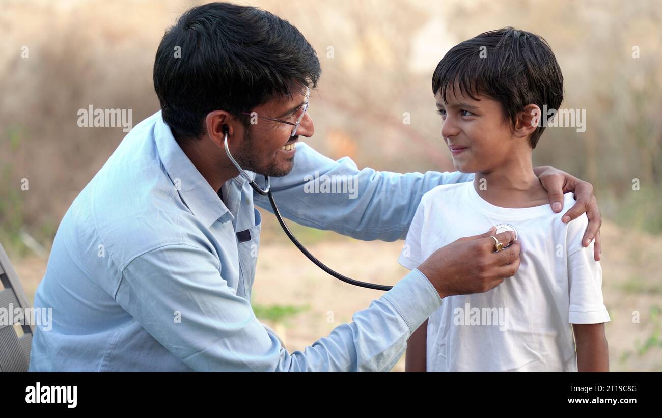 Indian young doctor of pediatrician holding stethoscope checking ...