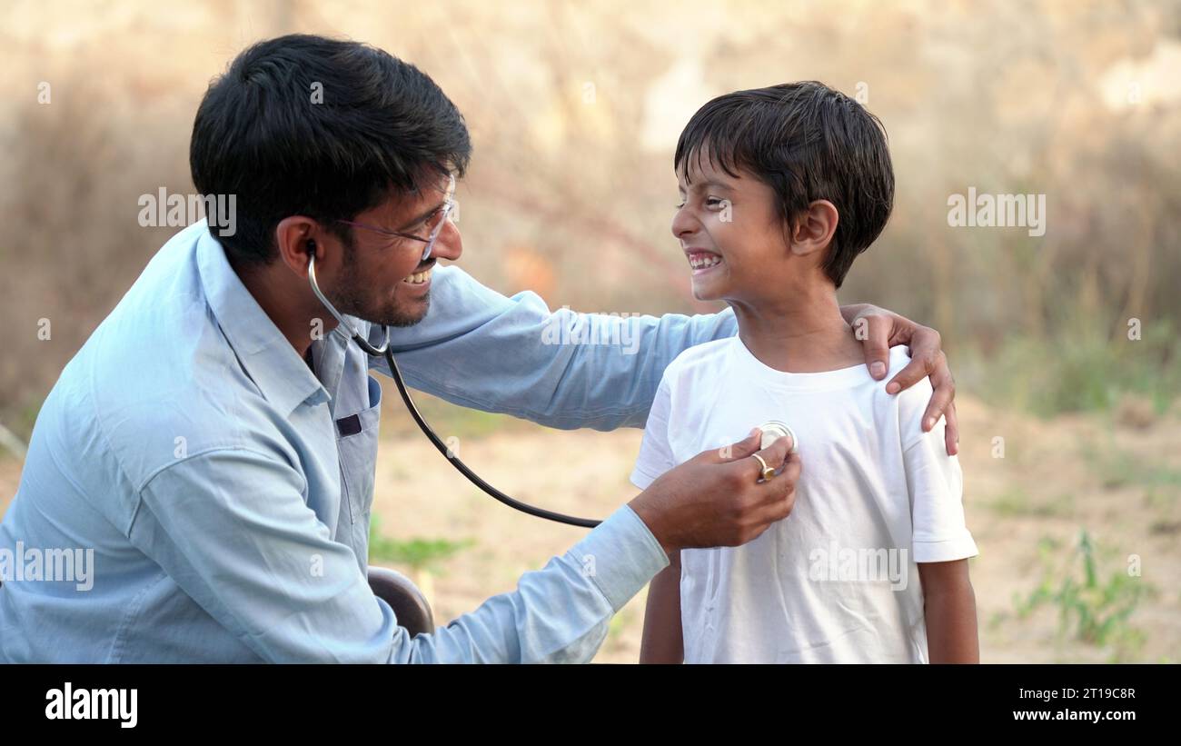Indian village doctor of pediatrician holding stethoscope checking ...