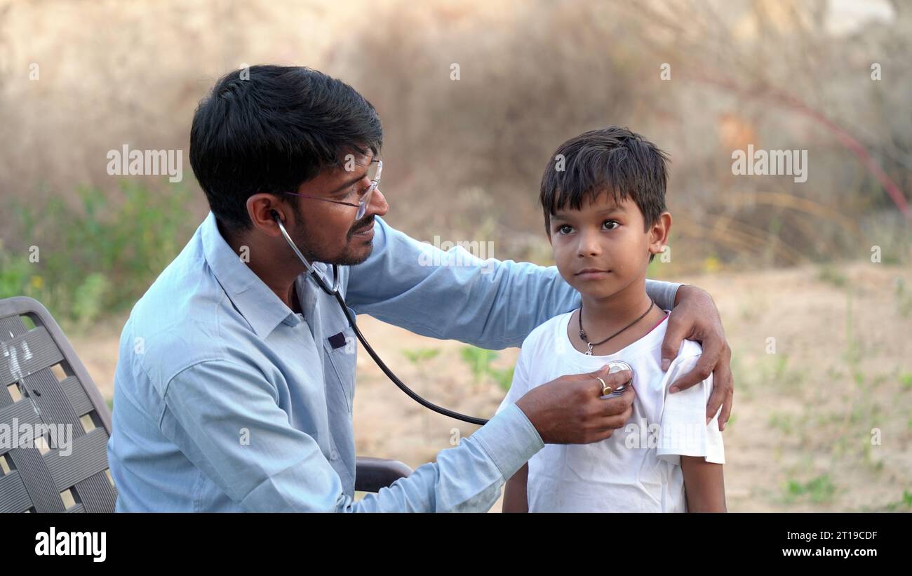 Indian young doctor of pediatrician holding stethoscope checking ...