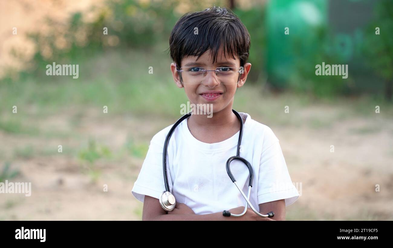Cute small Indian kid boy wear medical uniform holding stethoscope ...