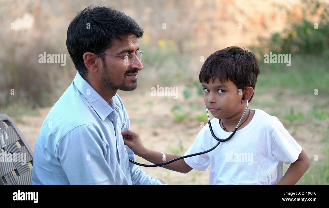 Indian kid doctor of pediatrician holding stethoscope checking ...