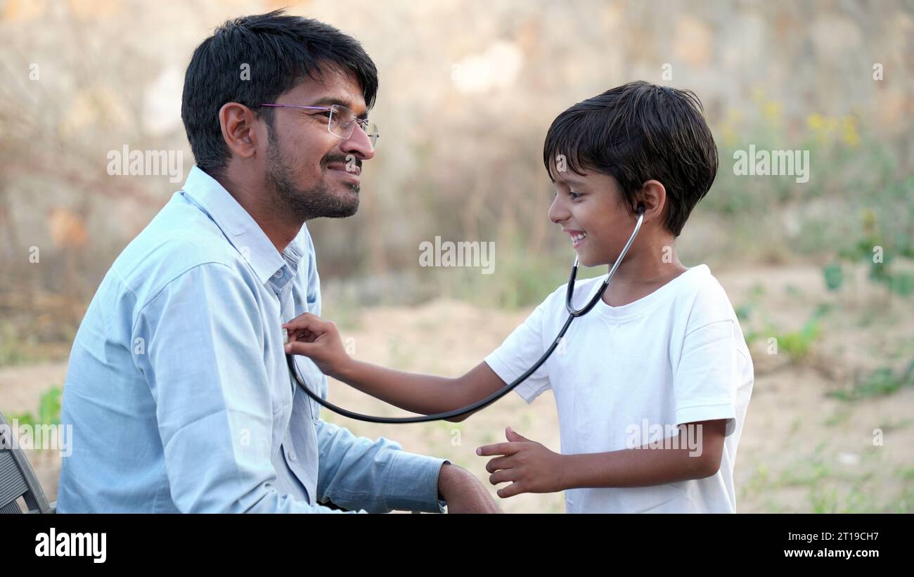 Indian kid doctor of pediatrician holding stethoscope checking ...