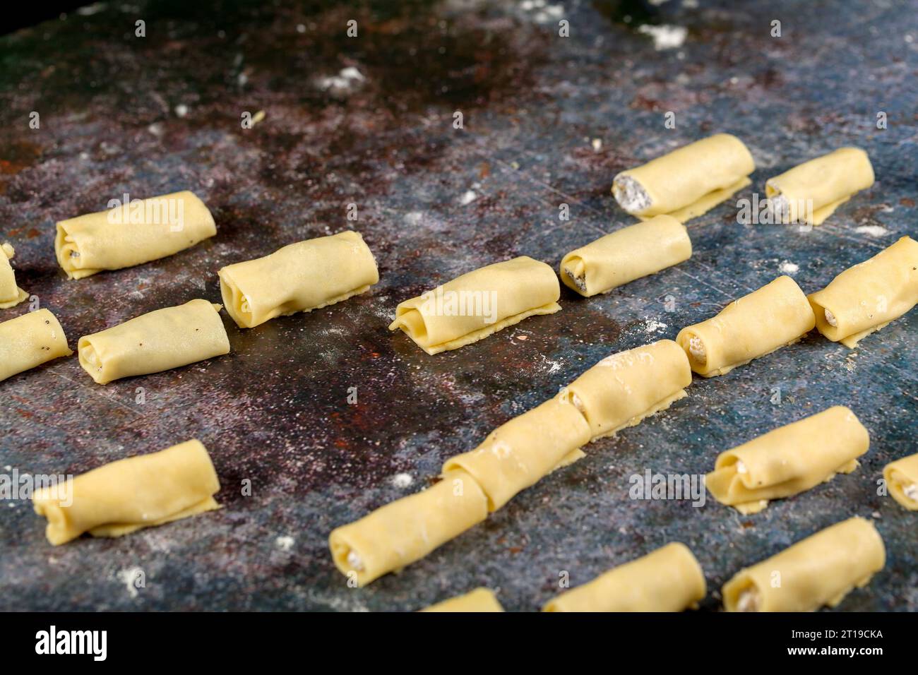 Formed puff pastry rolls with poppy seed and nut filling are ready for ...