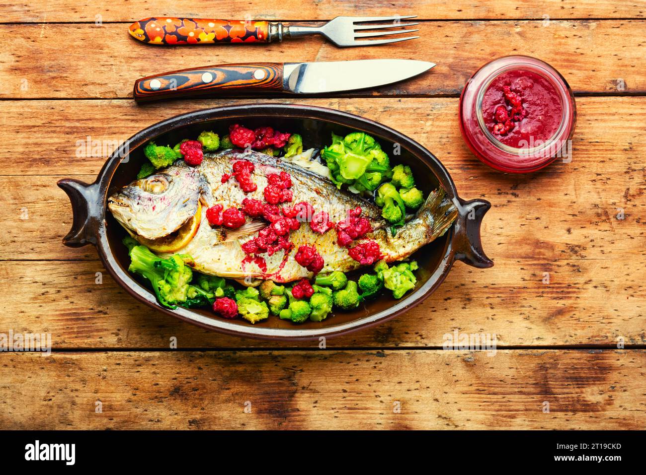 Baked whole fish dorado in fruit marinade,fish dish Stock Photo - Alamy