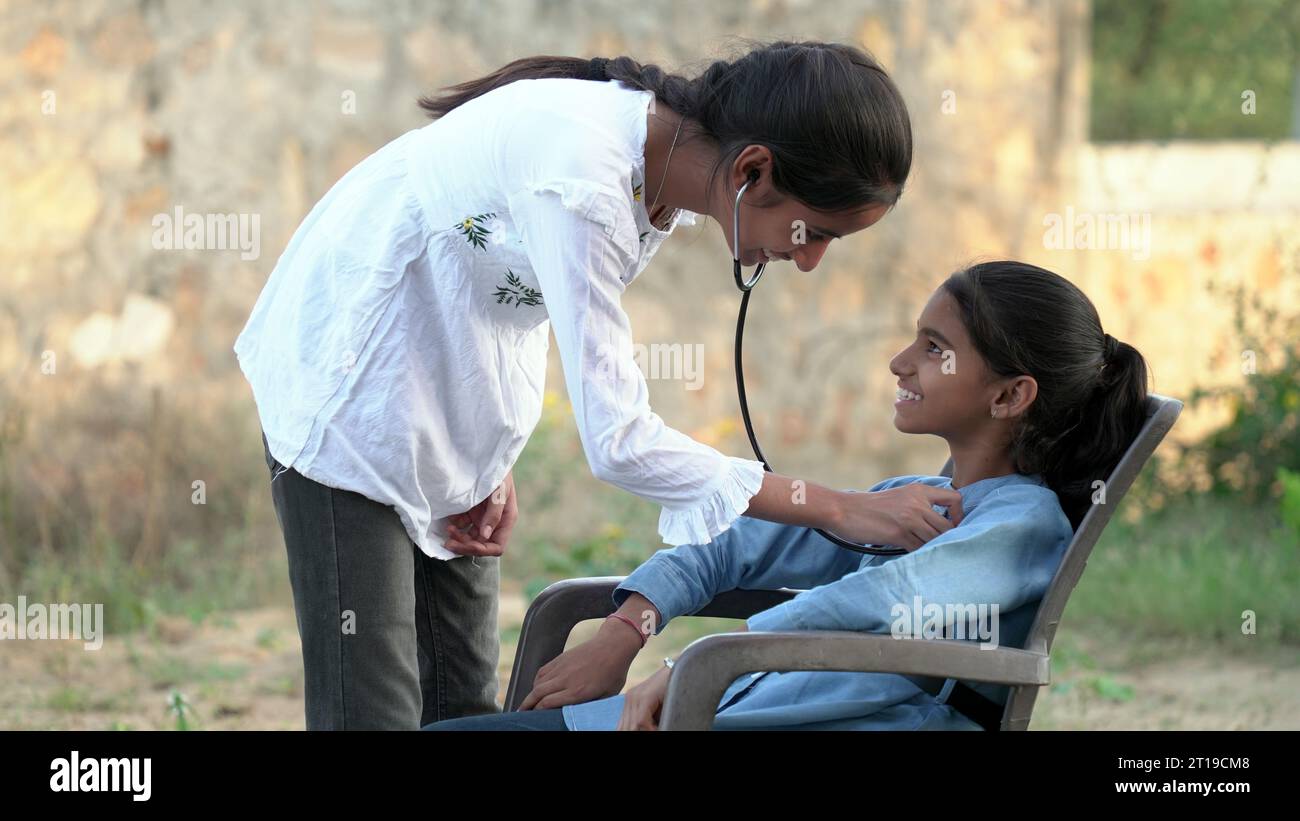 Female doctor or pediatrician with stethoscope listening to heartbeat ...