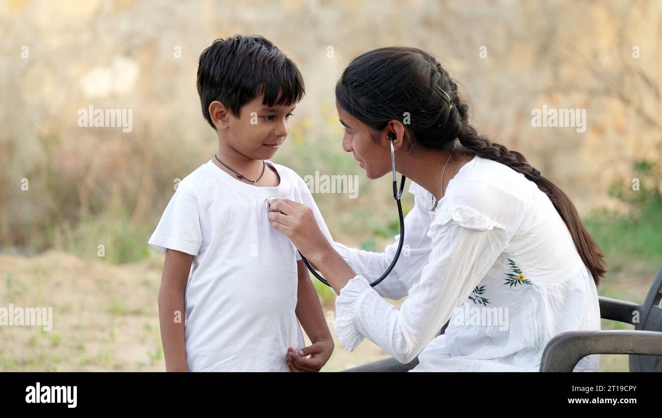 Female doctor or pediatrician with stethoscope listening to heartbeat ...