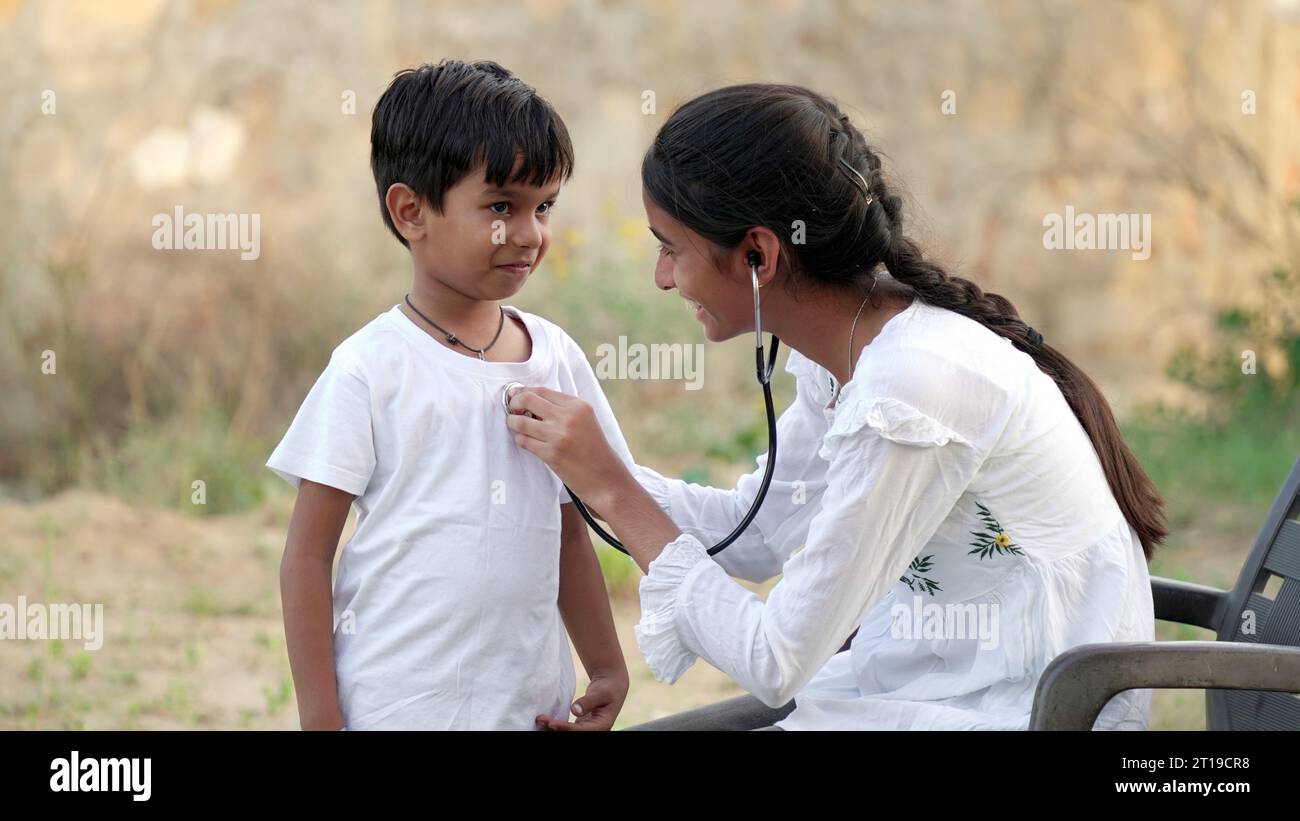 Indian young doctor of pediatrician holding stethoscope checking ...