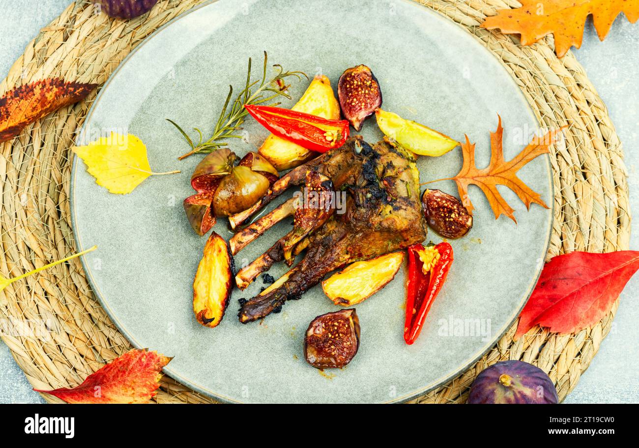 Lamb meat on the ribs, roasted with figs. Rack of lamb Stock Photo - Alamy