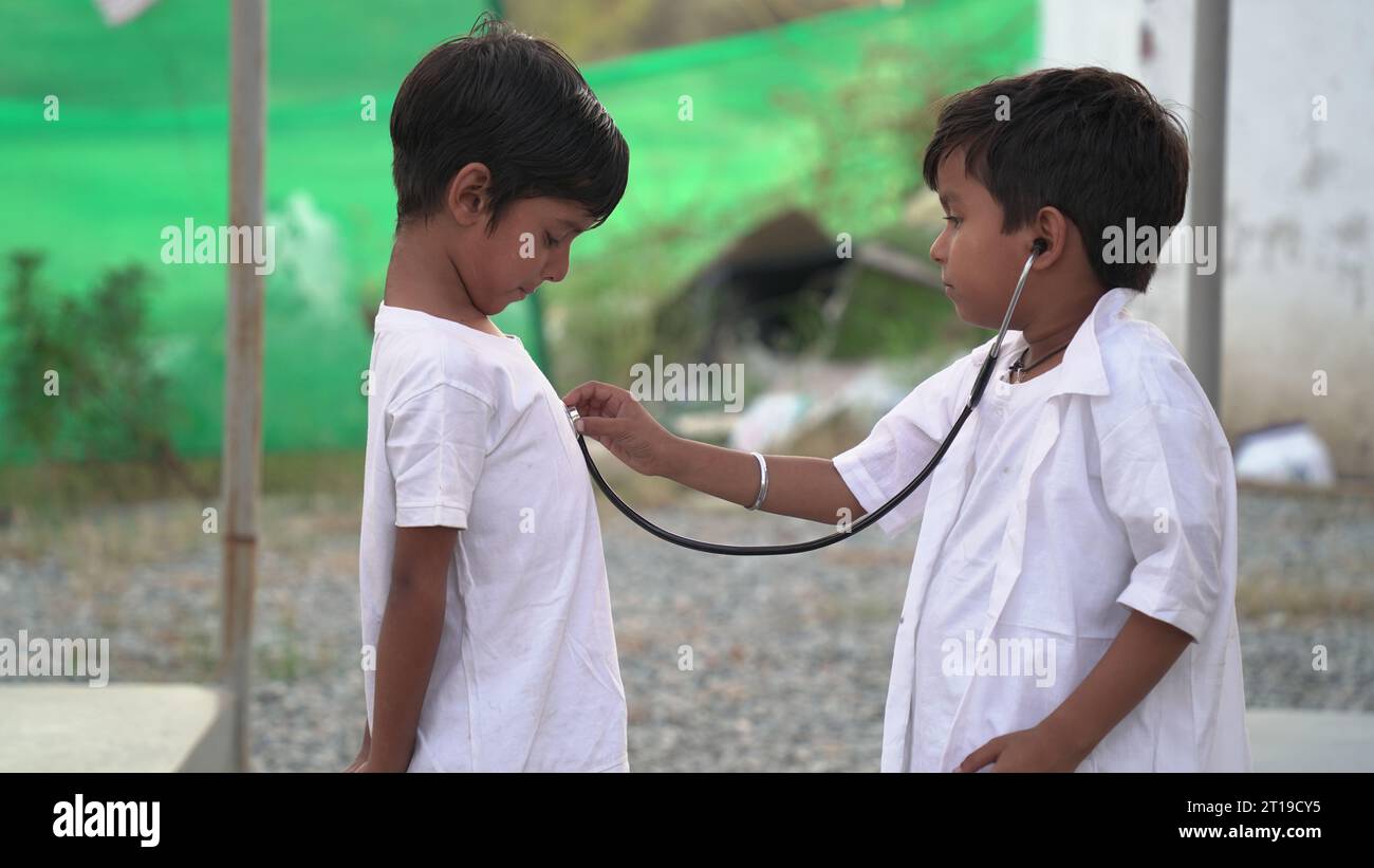 Indian kid doctor of pediatrician holding stethoscope checking ...
