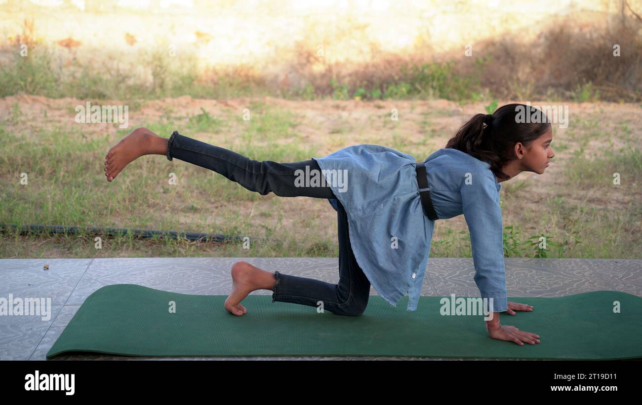 Portrait of gorgeous kid practicing yoga outdoor. Beautiful child ...