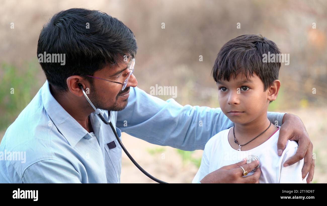 Indian young doctor of pediatrician holding stethoscope checking ...