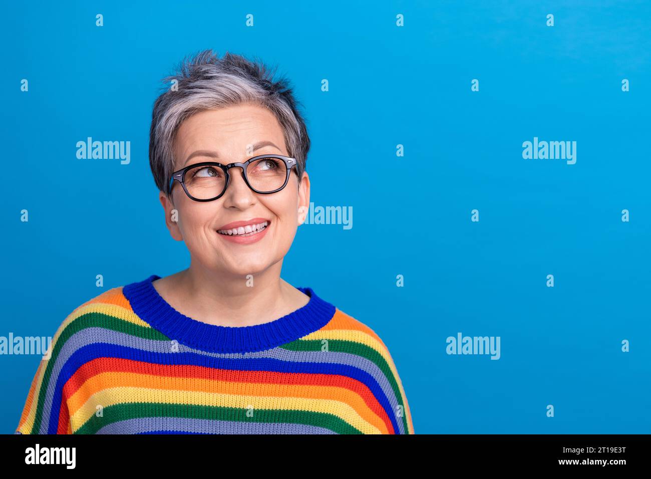 Photo of positive nice person toothy smile look empty space contemplate ...