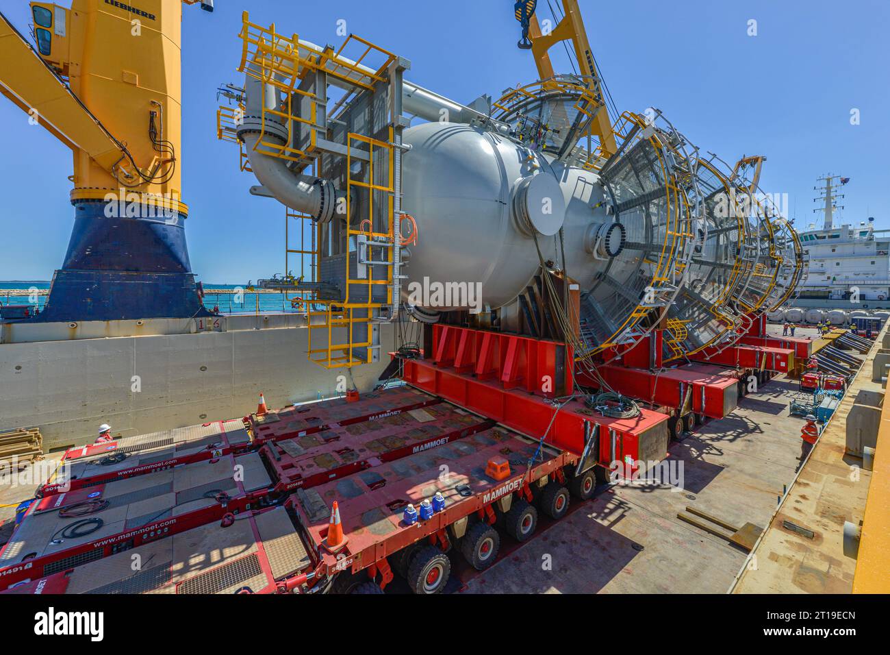 Off-shore oil platform stairwell being loaded on to a ship for ...