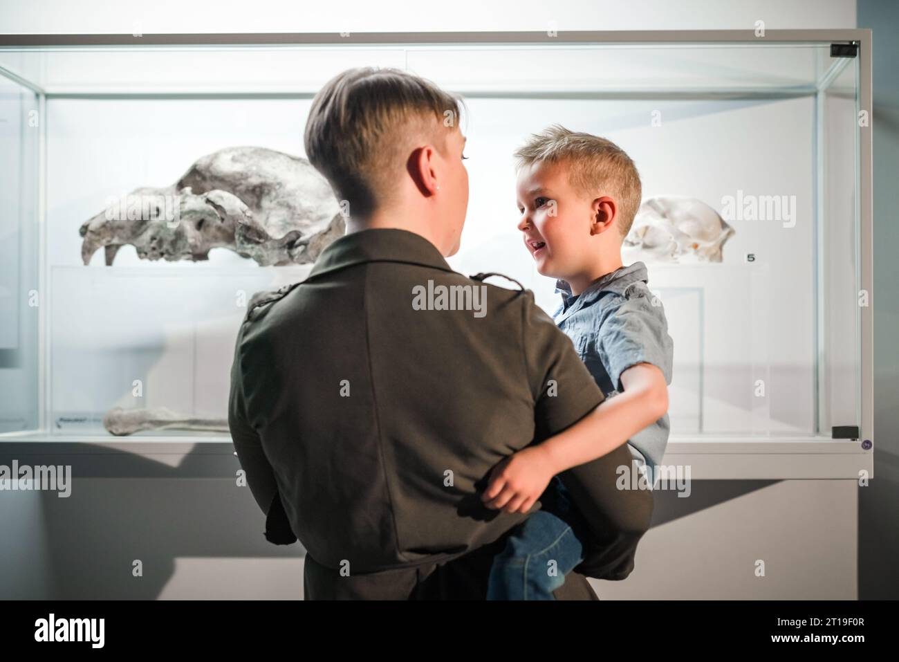 Mother and her little son enjoying watching an exhibition in a natural ...