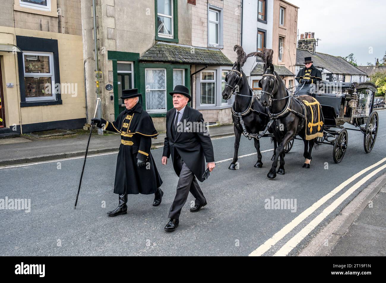 Funeral cortège with the funeral director leading a Victorian glass ...
