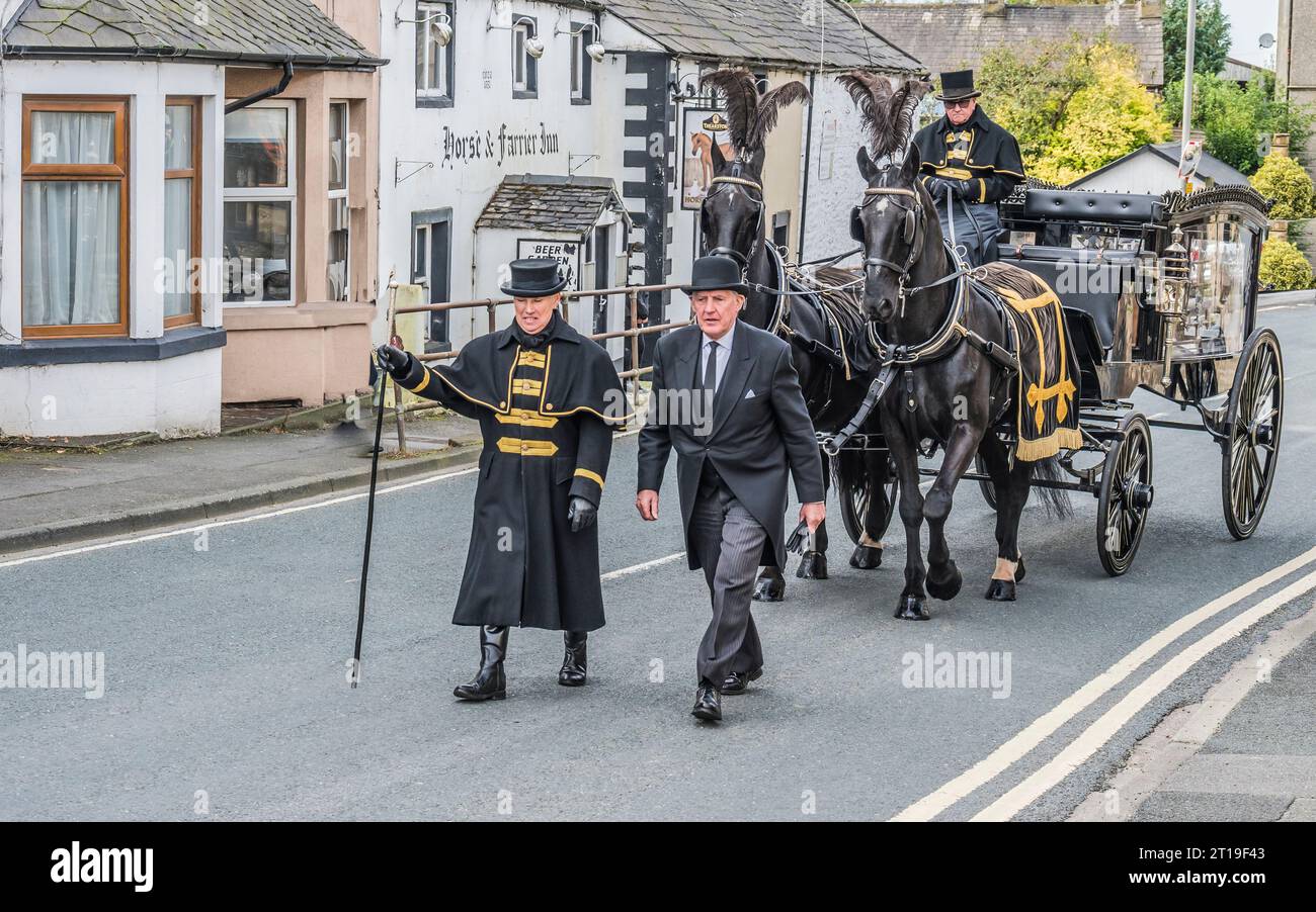 Funeral cortège with the funeral director leading a Victorian glass ...