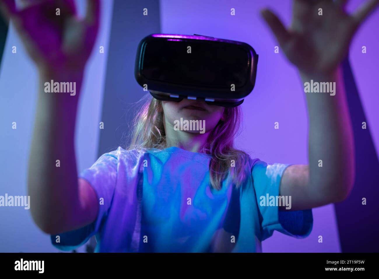 Female child using new technologies, having fun wearing virtual reality ...