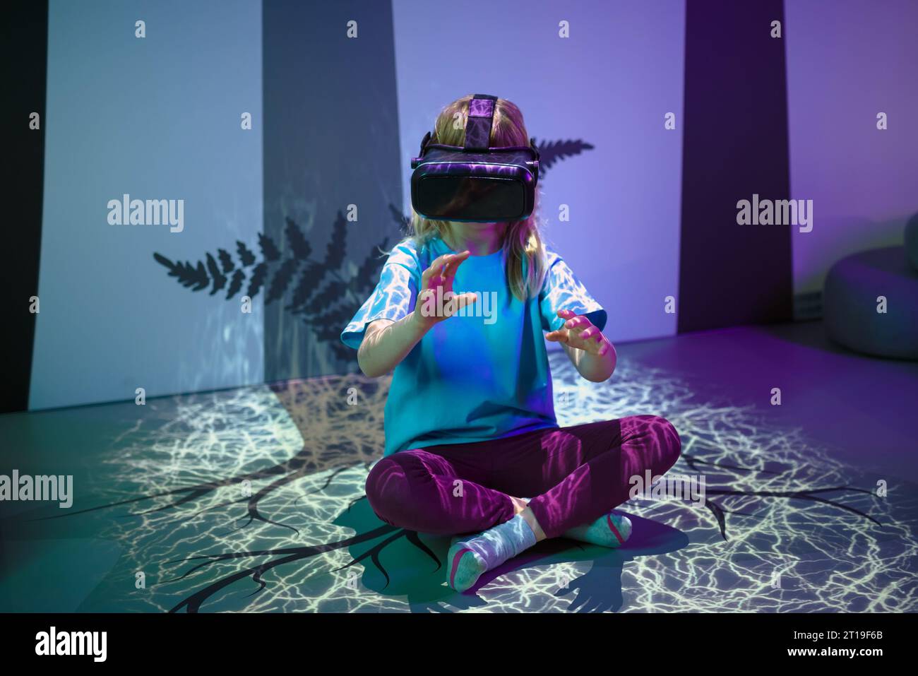 Female child using new technologies, having fun wearing virtual reality ...