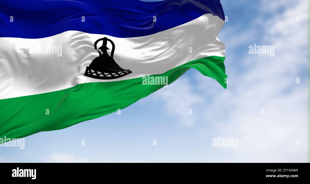 National flag of Lesotho waving in the wind on a clear day. Three ...