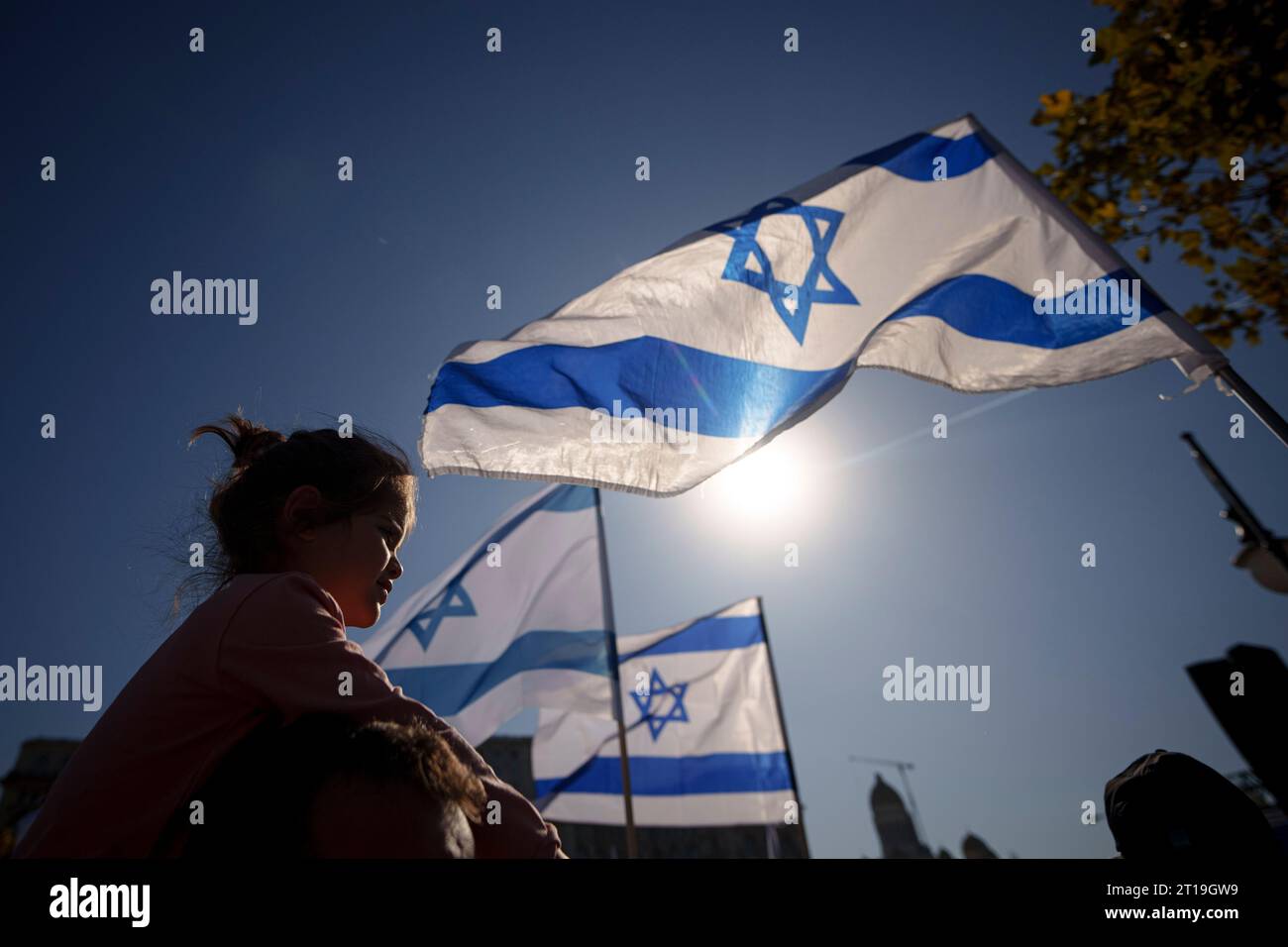 Roni, 4, sits on her father's shoulders during a rally in support of ...