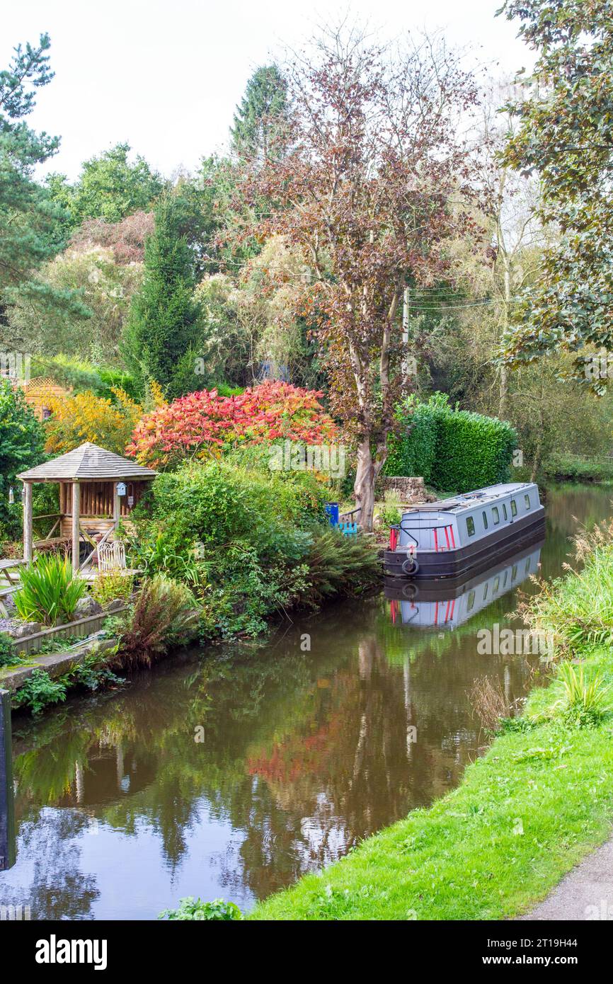 Canal narrowboat moored alongside gardens on the Caldon canal in the ...