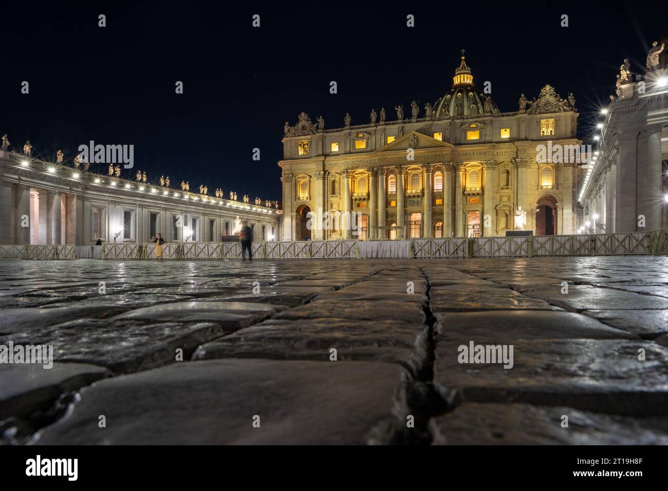 The famous St. Peter's Square in front of the Vatican at night with ...