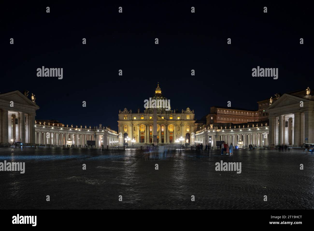 The famous St. Peter's Square in front of the Vatican at night with ...