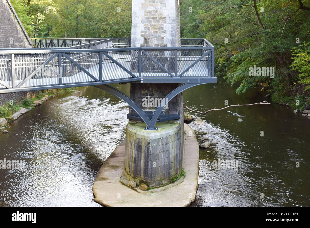 pedestrian bridge attached to a stone railroad bridge Stock Photo - Alamy