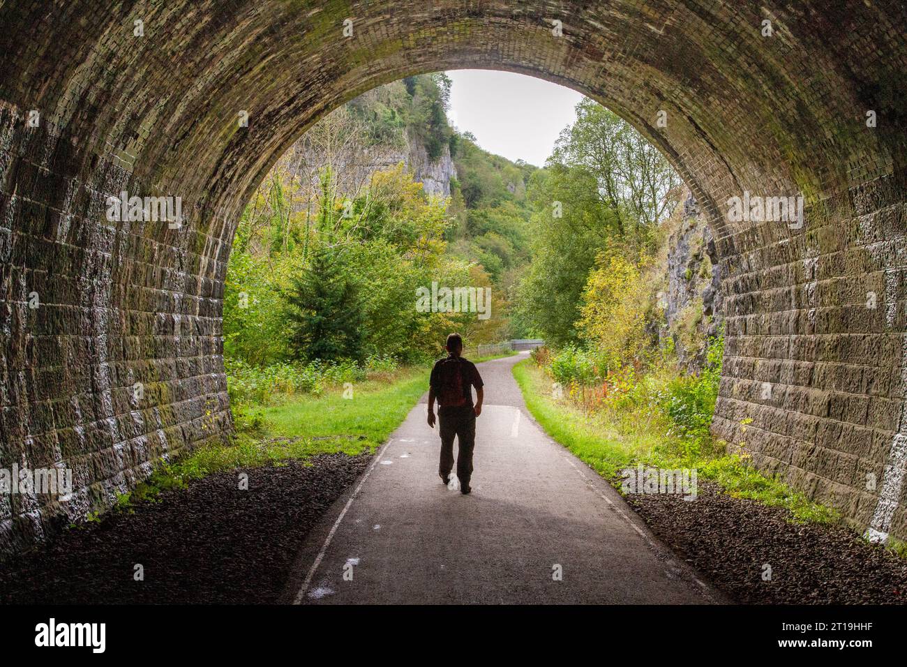 Man walking on the Monsal Trail footpath through a disused railway ...