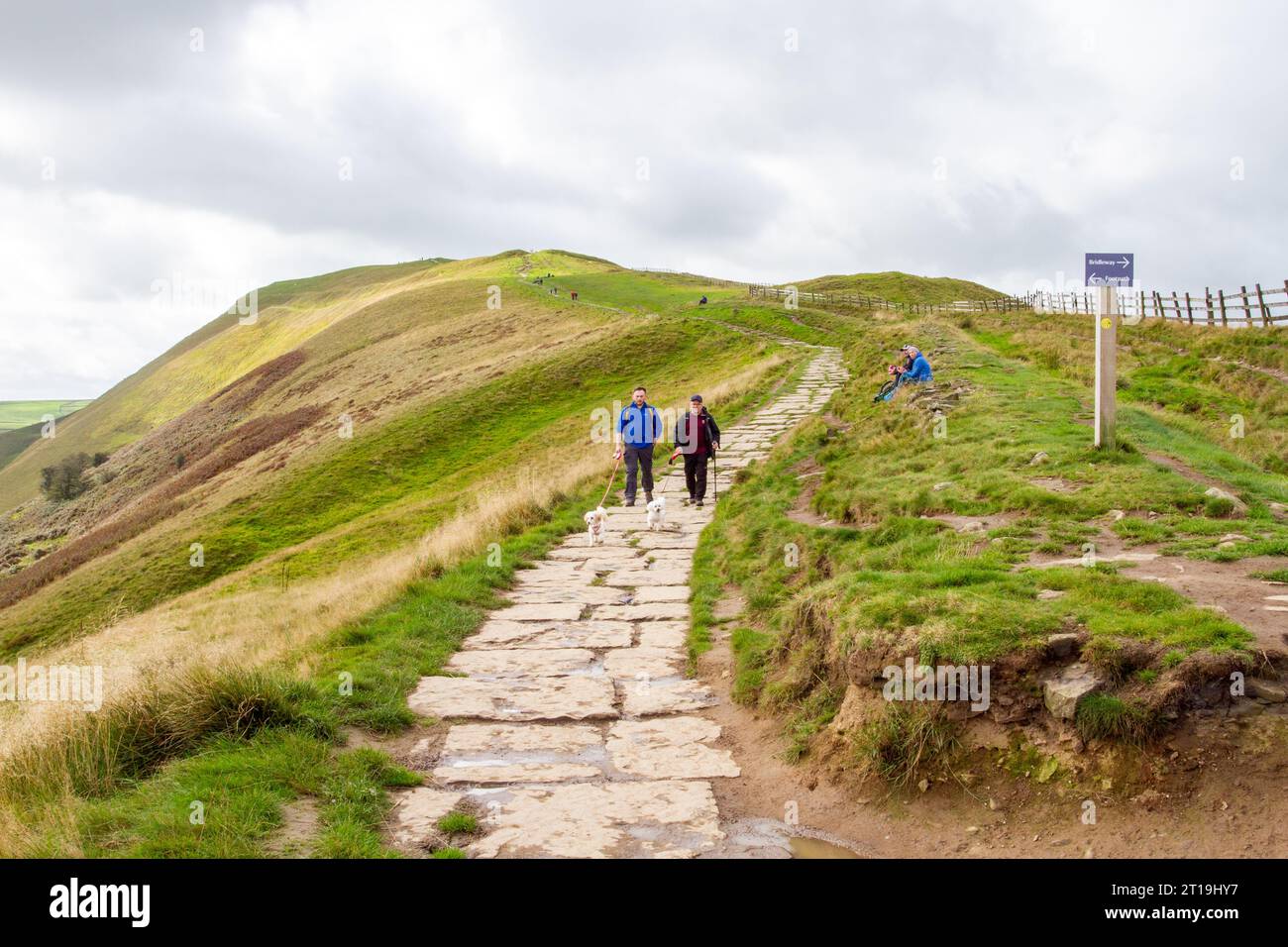 People climbing the flagstones down from the summit of Mam Tor the on ...