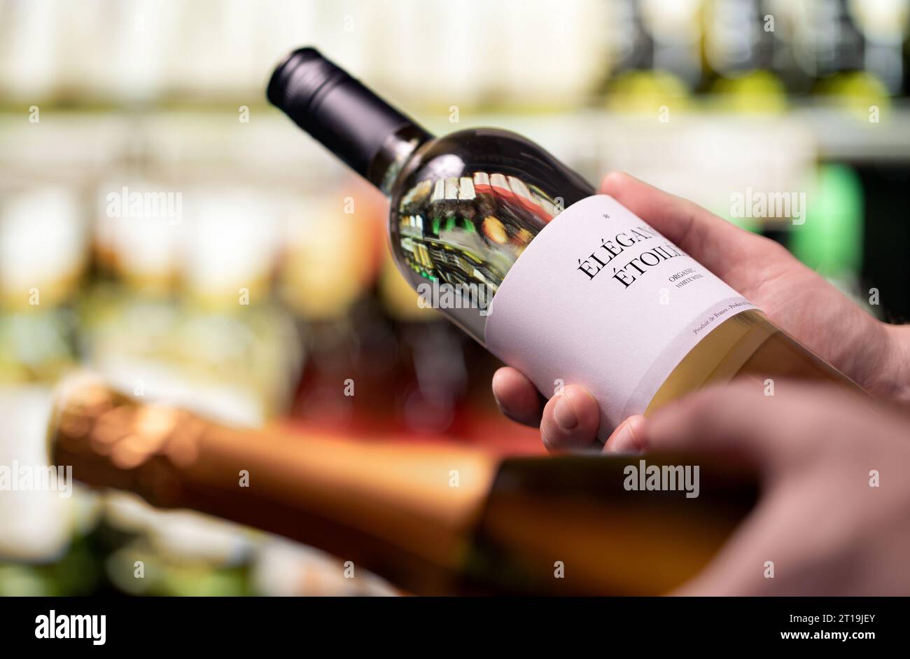 Wine shop and alcohol store. White chardonnay or riesling. Man holding ...