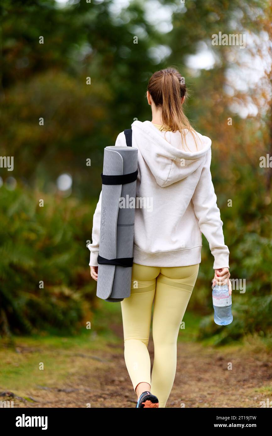 Woman walking outdoors Stock Photo - Alamy