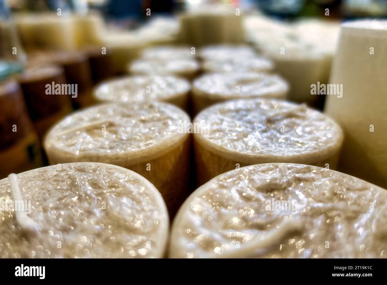 set of candles with white wick in a row, close-up, top view. A template ...