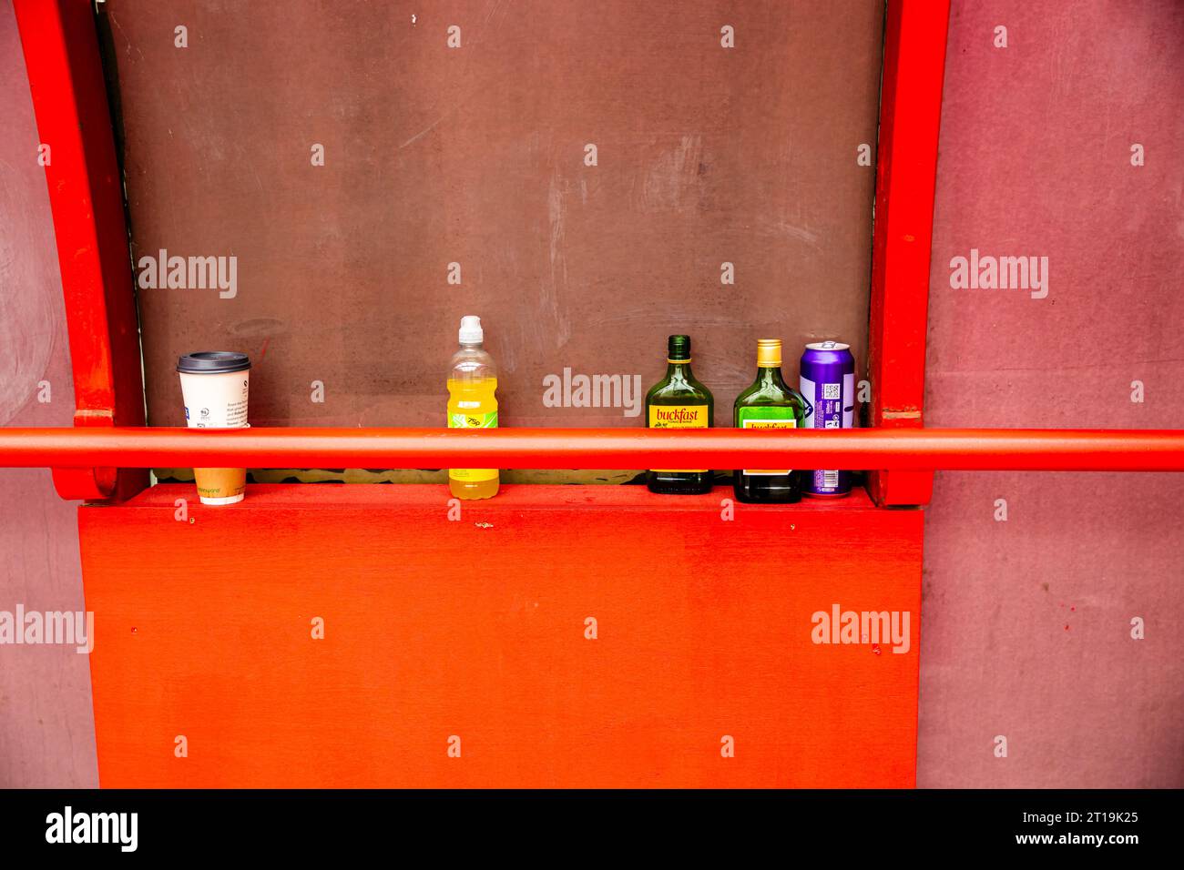 Plastic and glass drink bottles, such as Buckfast placed on a ledge in ...