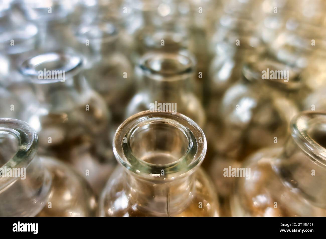 a set of transparent and shining glass bottles, close up image from the ...