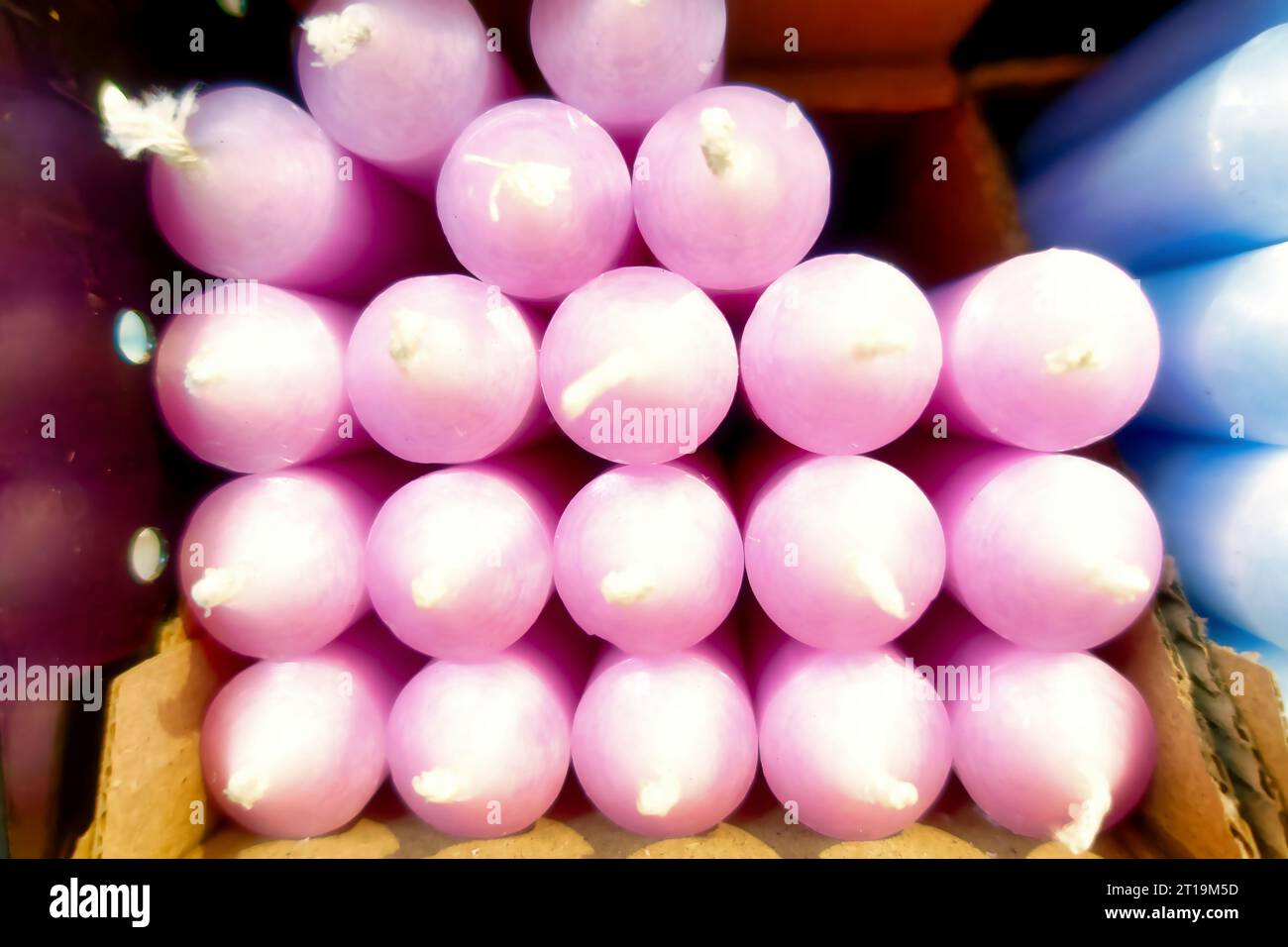 set of pink candles with white wick in a row, close-up, top view. A ...