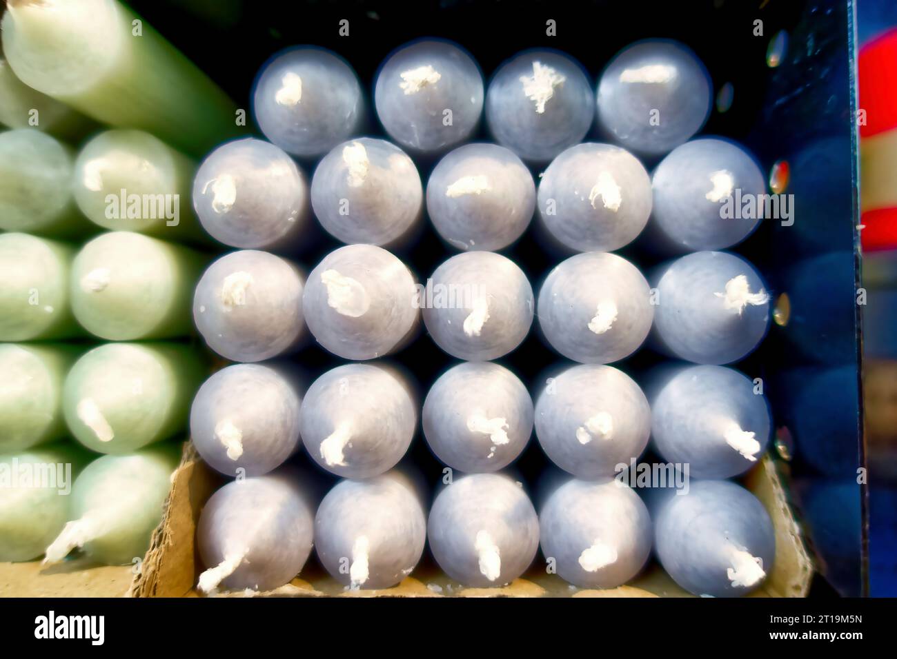 set of blue candles with white wick in a row, close-up, top view. A ...