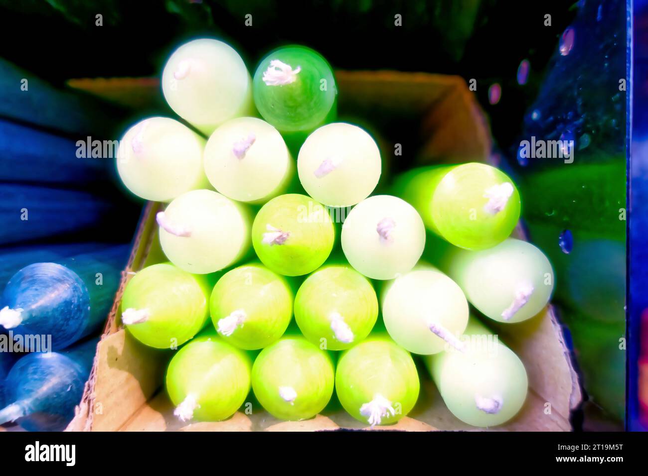 set of mixed colored candles with white wick in a row, close-up, top ...