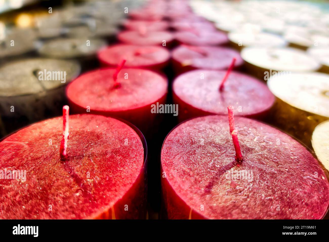 set of red candles with white wick in a row, close-up, top view. A ...