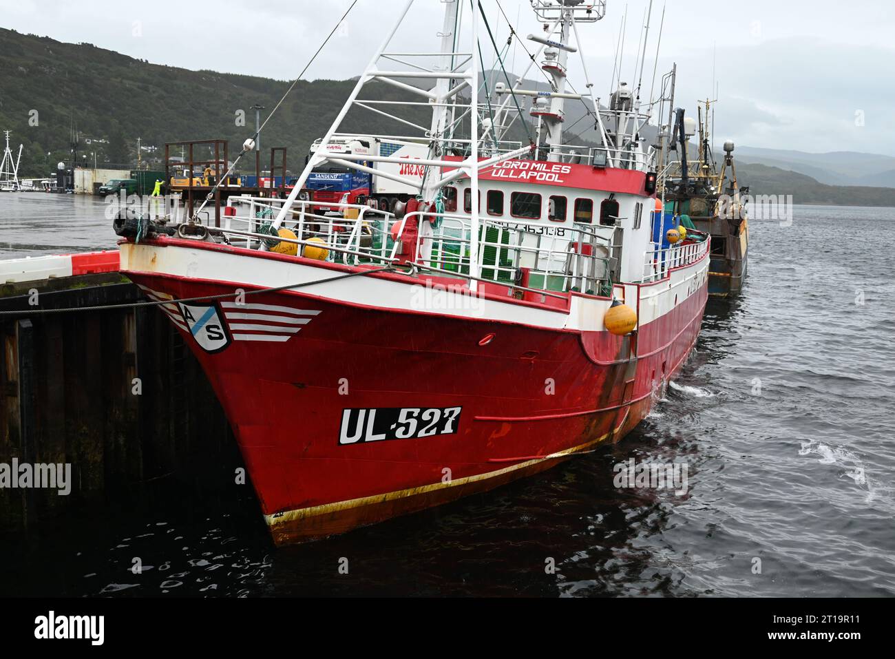 After a campaign at sea, a trawler unloads its catch in the harbour of ...