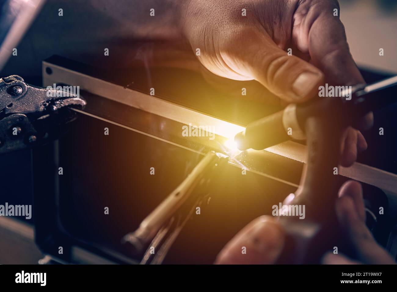 Metal welder works with a steel welder in a factory Stock Photo - Alamy