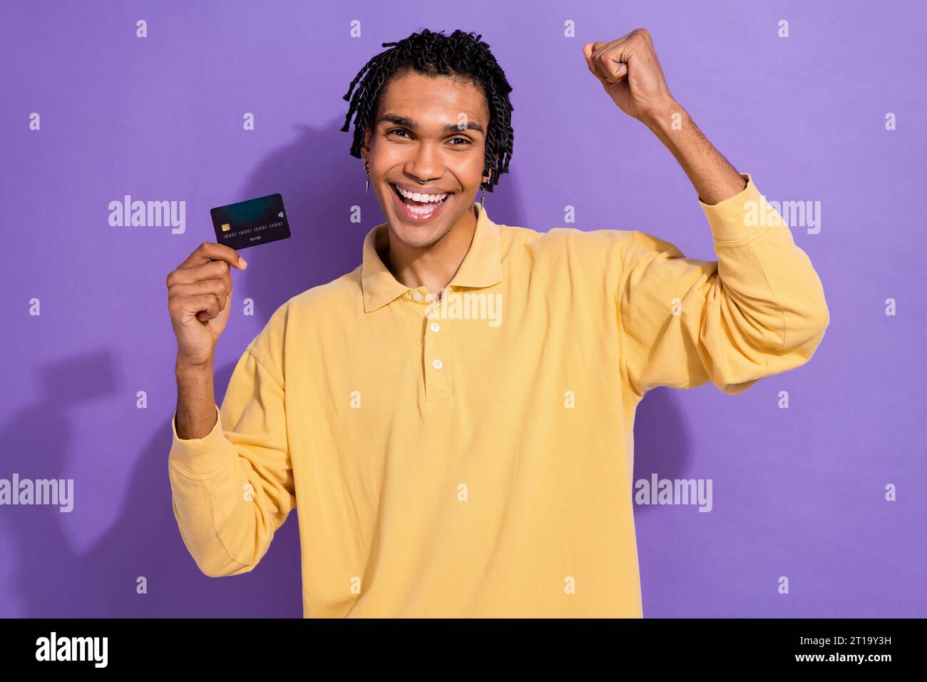Photo of overjoyed youngster man wear yellow trendy clothes raise hand ...