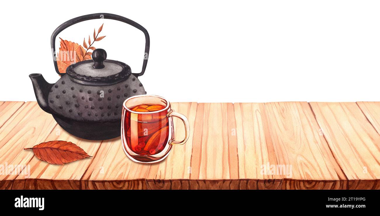 Brewed black tea in glass cup and teapot with autumn leaves on wooden ...